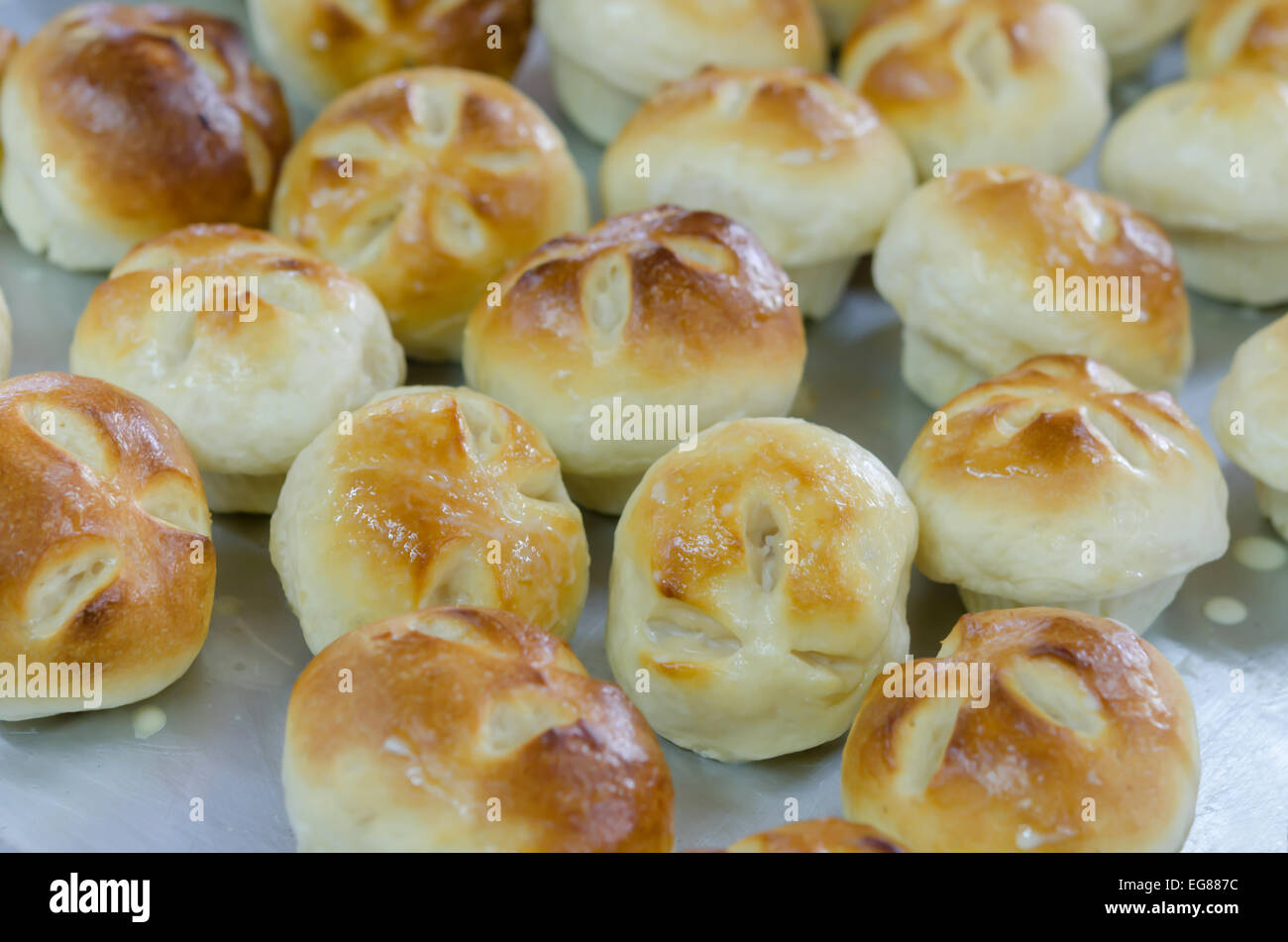 Tasty buns on oven-tray Stock Photo - Alamy