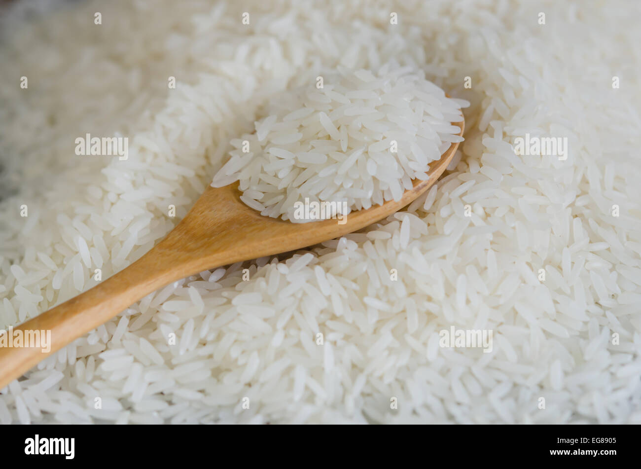 Wooden spoon with rice lying against the background rice Stock Photo ...
