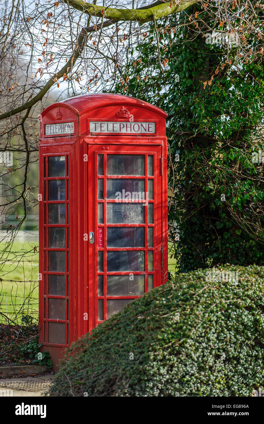 Traditional red public telephone box kiosk on a street in England, UK ...