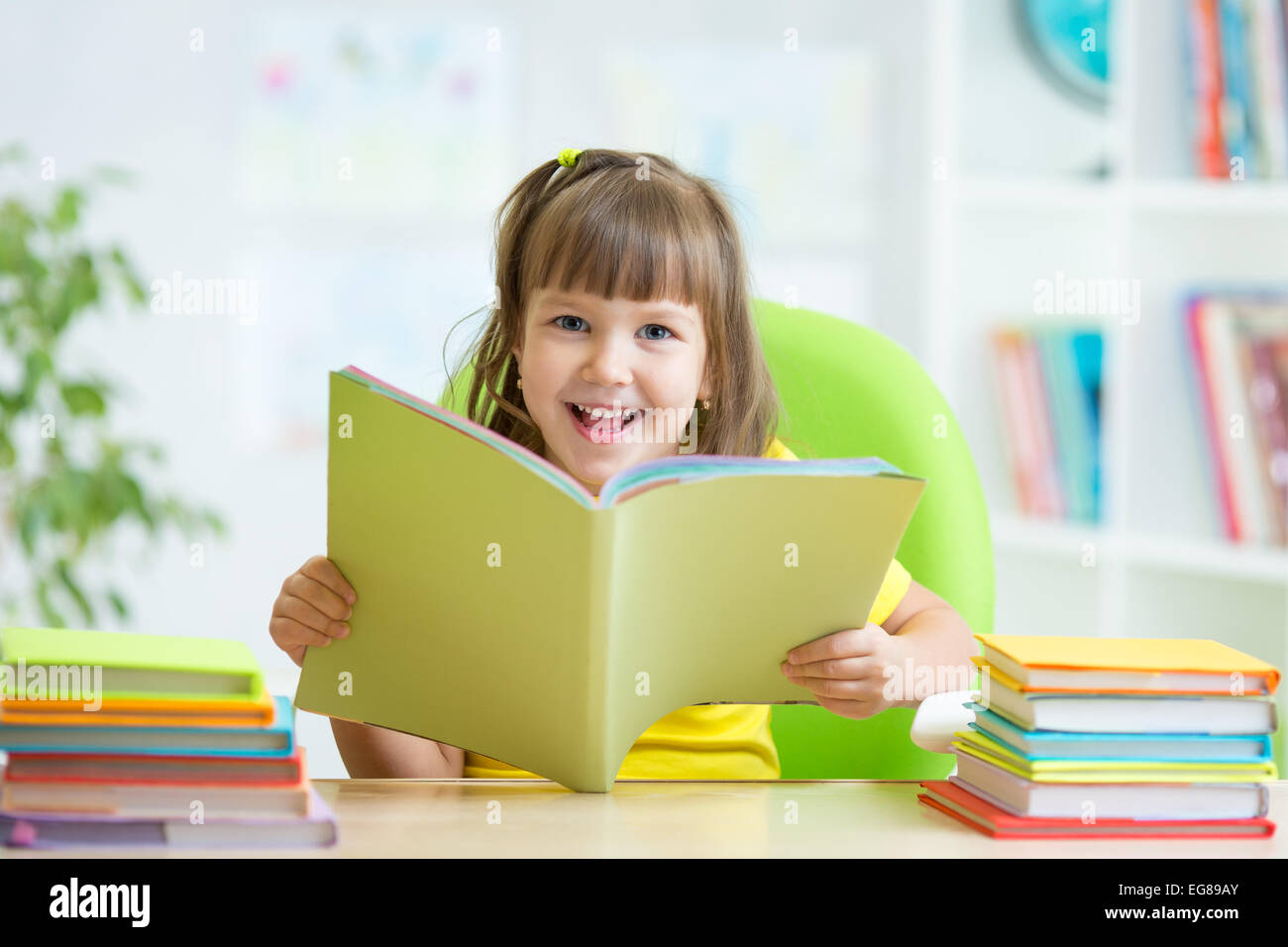 Happy child with opened book Stock Photo - Alamy