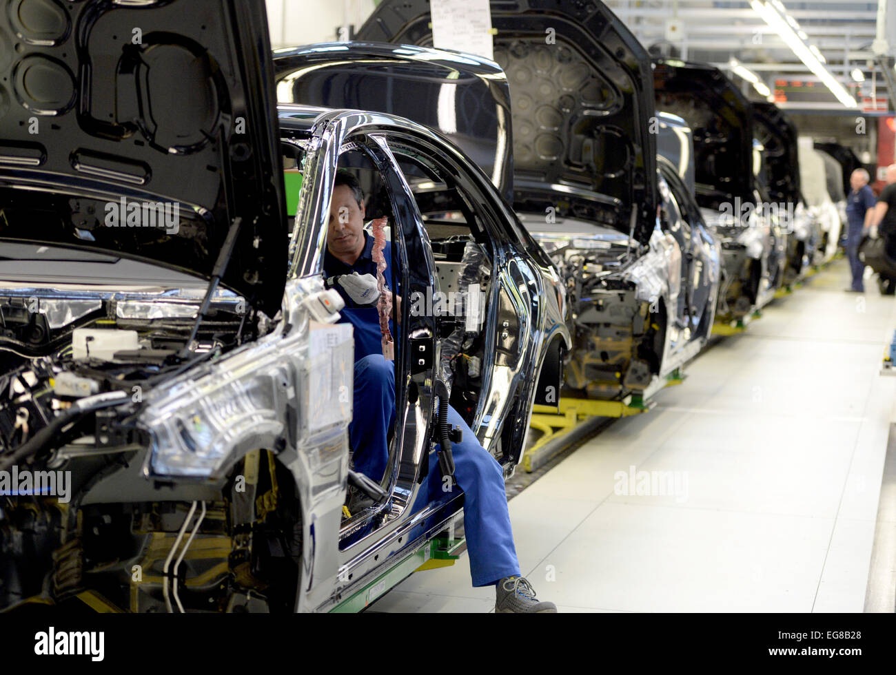 Employees are busy at work on the production line for a Mercedes S ...