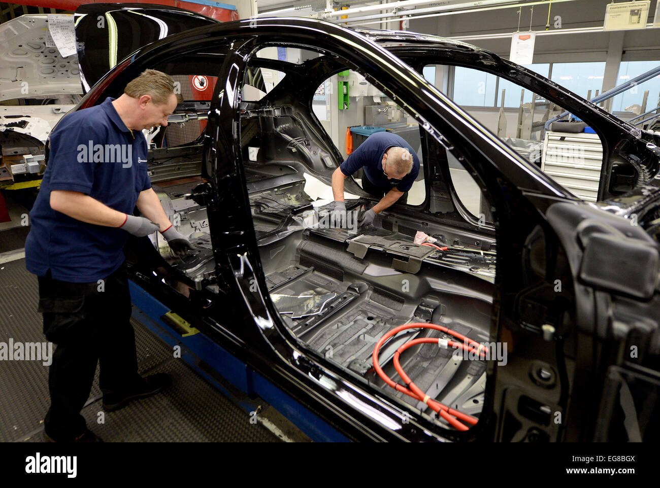 Employees are busy at work on the production line for a Mercedes S ...