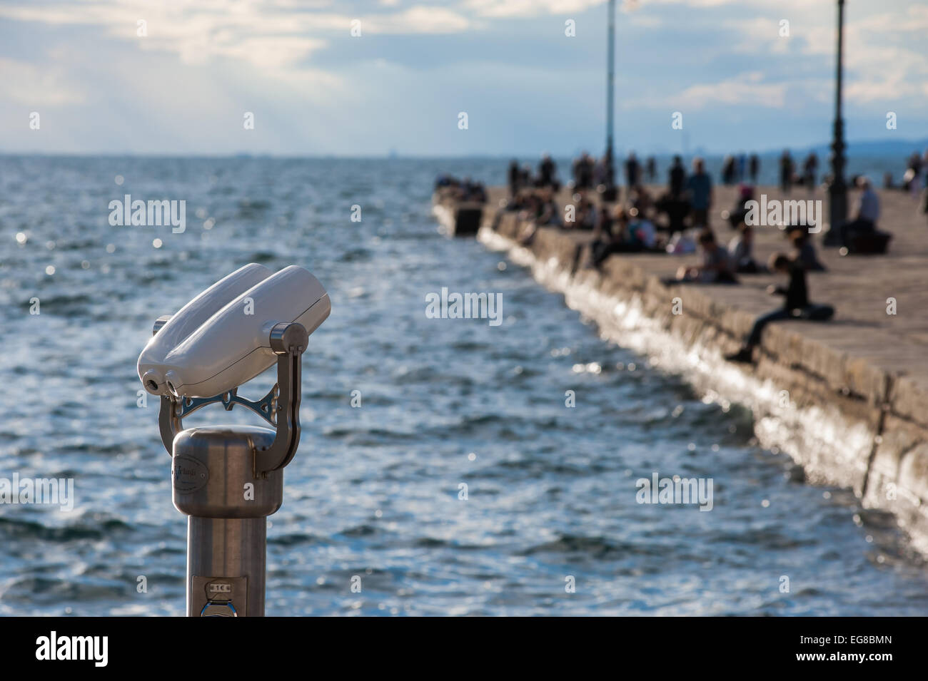 A binocular overlooking the seafront and Molo Audace in Trieste, Italy ...