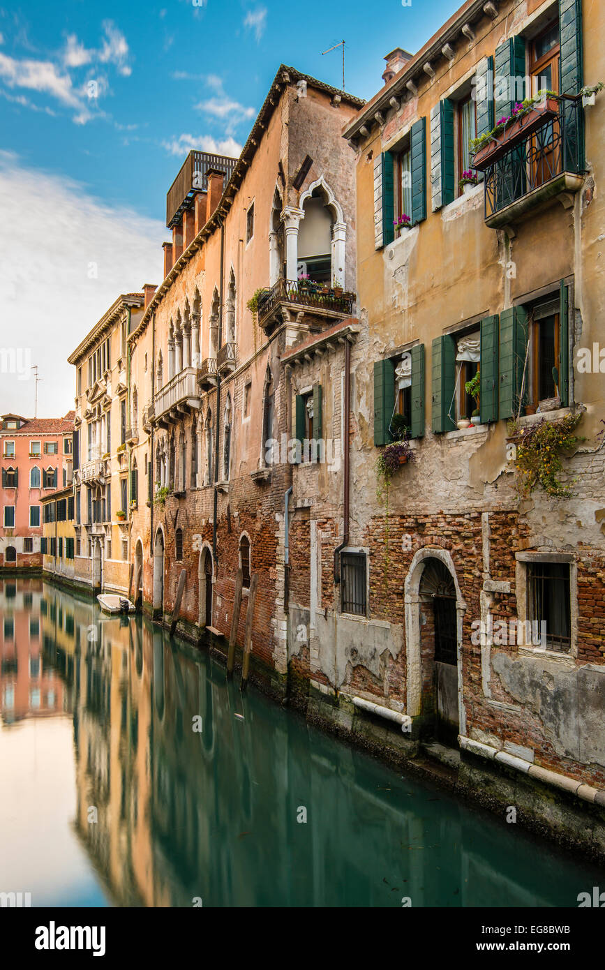 Historical buildings reflected into a water canal, Venice, Veneto ...