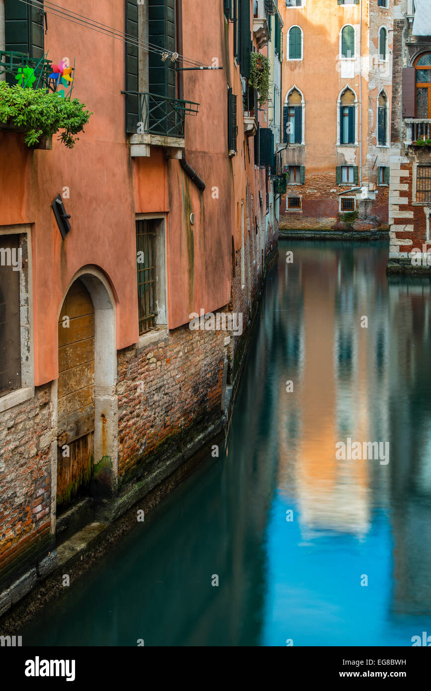 Historical buildings reflected into a water canal, Venice, Veneto ...
