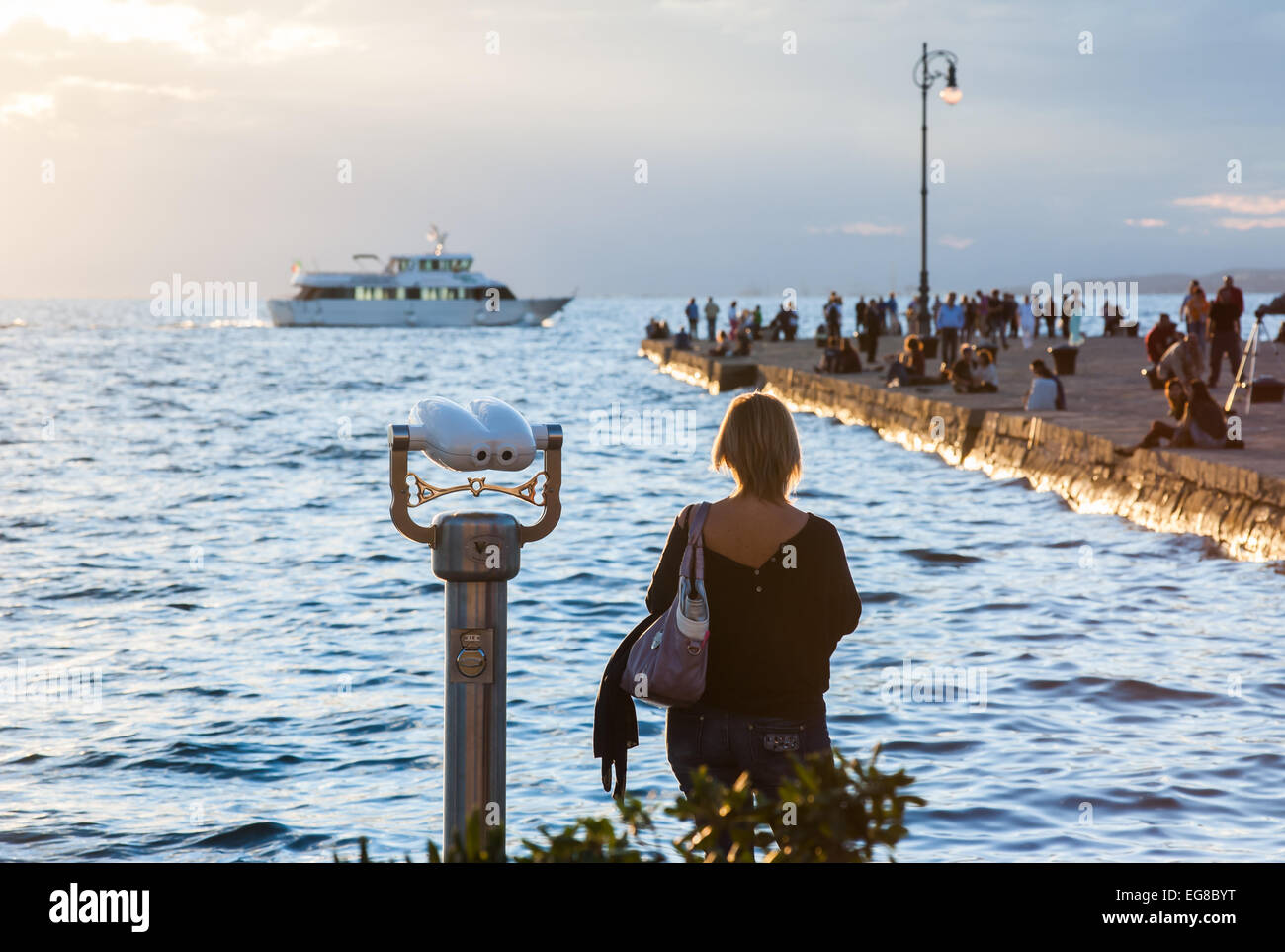 The waterfront and the Molo Audace in Trieste, Italy with people ...
