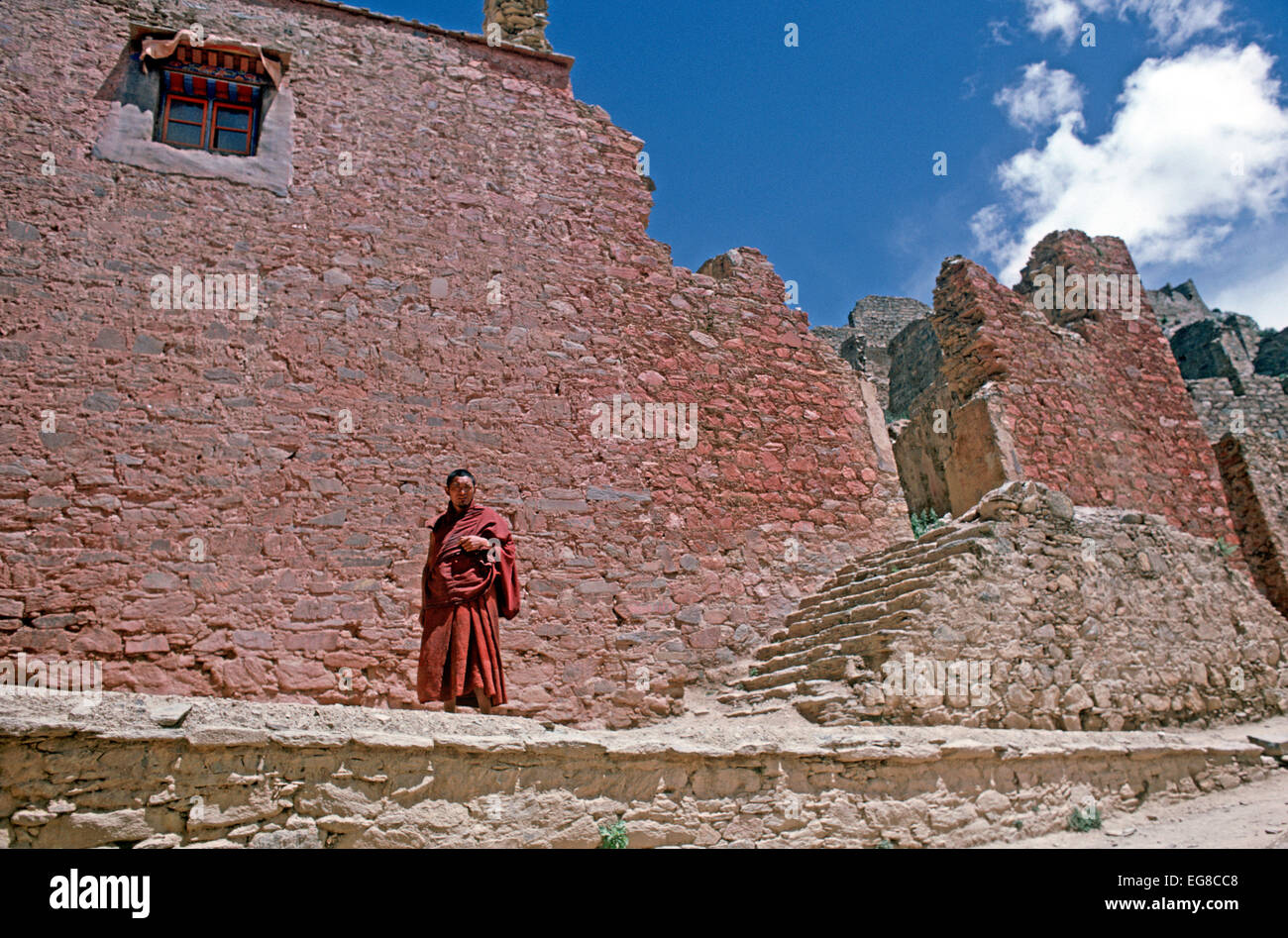 Buddhist monk amongst the ruins of Ganden Monastery destroyed by the ...
