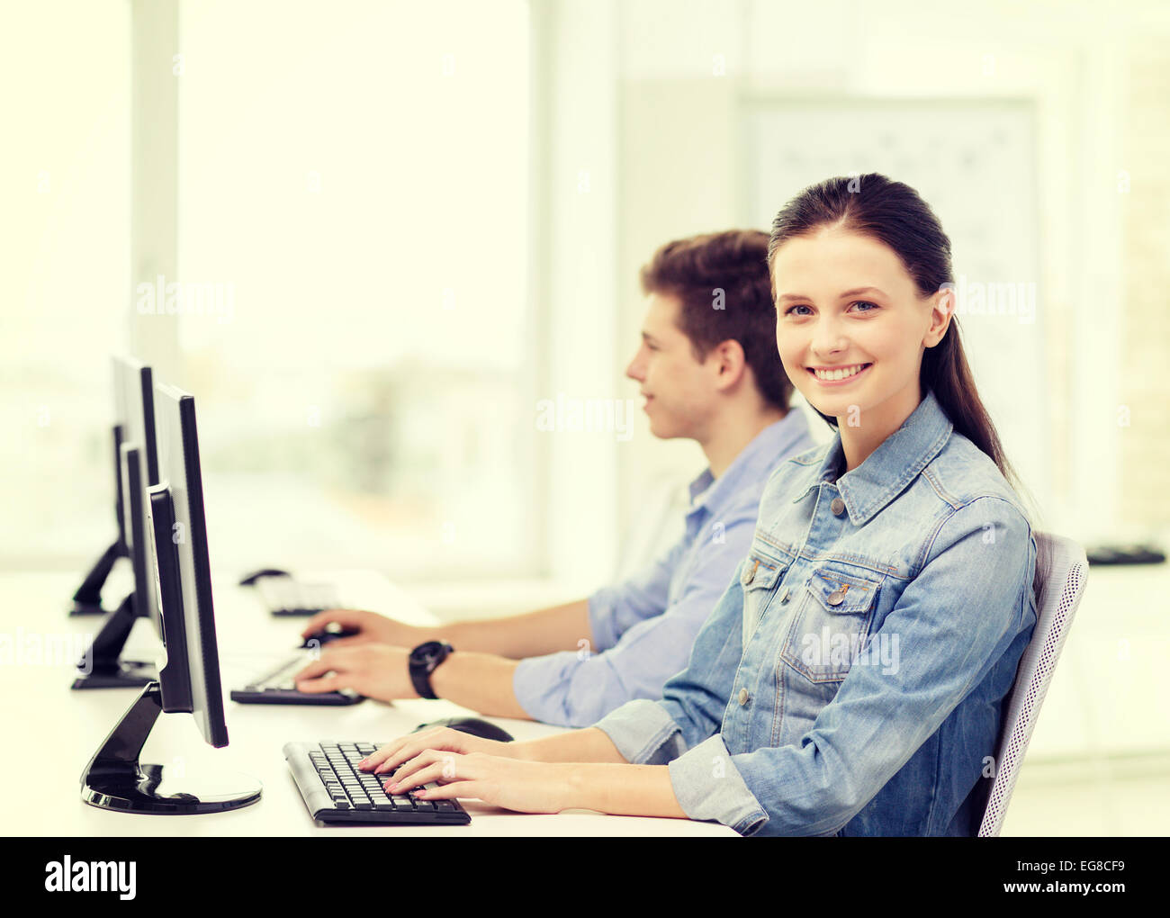 two smiling students in computer class Stock Photo - Alamy