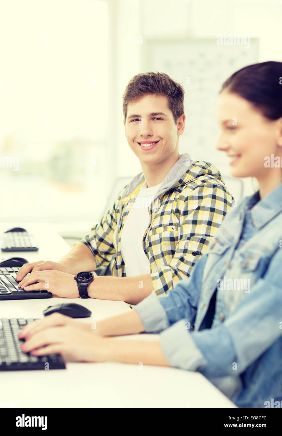 smiling boy with girl in computer class at school Stock Photo - Alamy