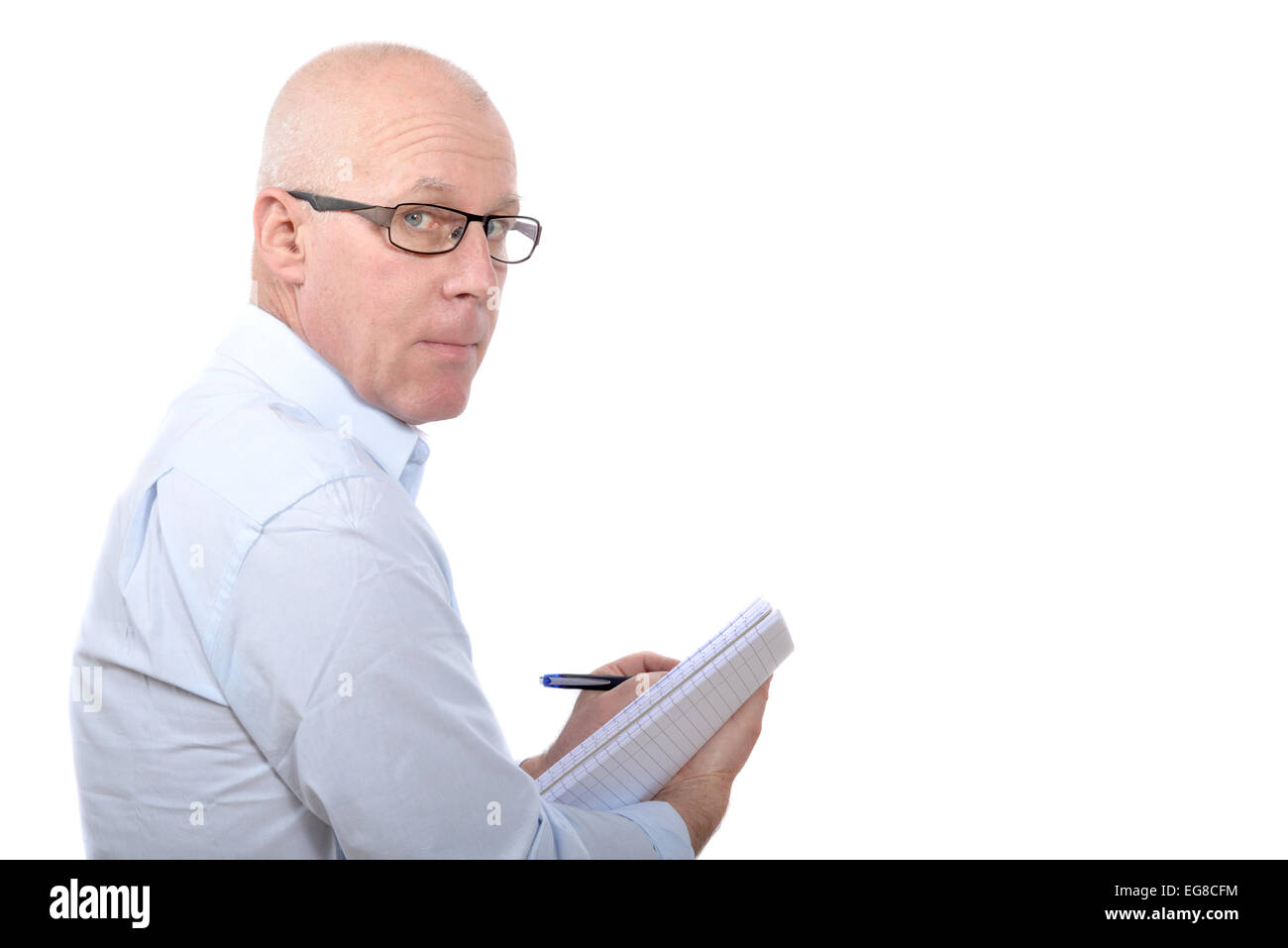 Man standing in blue shirt with a notebook in hands Stock Photo - Alamy