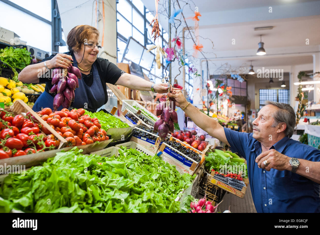 Trieste, Italy - A woman works in a food stall in the Mercado Coperto ...