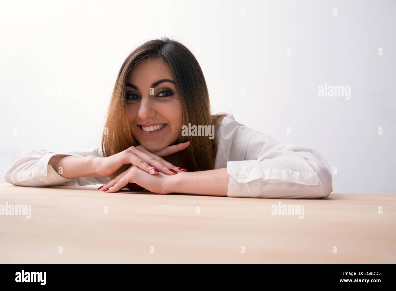 Beautiful happy woman lying on the table Stock Photo - Alamy