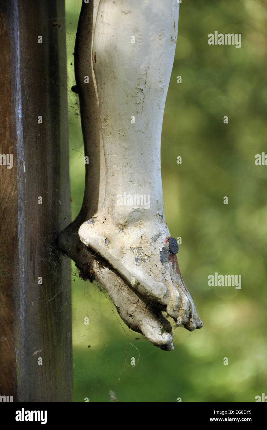 Detail of a crucifix. The feet of Jesus Christ nailed at a wooden cross Stock Photo - Alamy