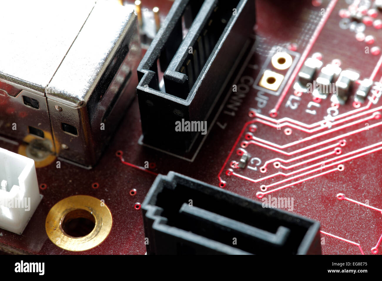 Red circuit board closeup showing two black SATA ports Stock Photo - Alamy