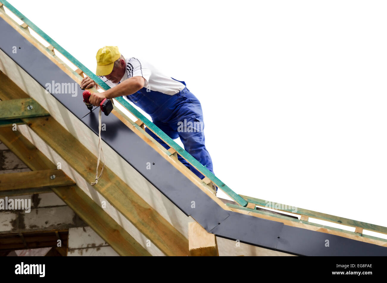 A worker standing on the scaffolding and finishing a roof Stock Photo ...