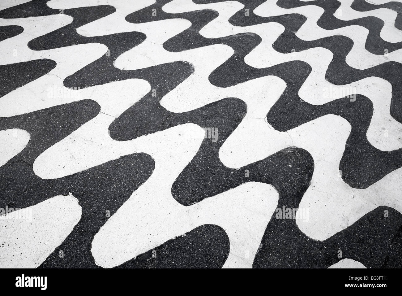 Curved black and white abstract pattern of urban roadside pavement ...