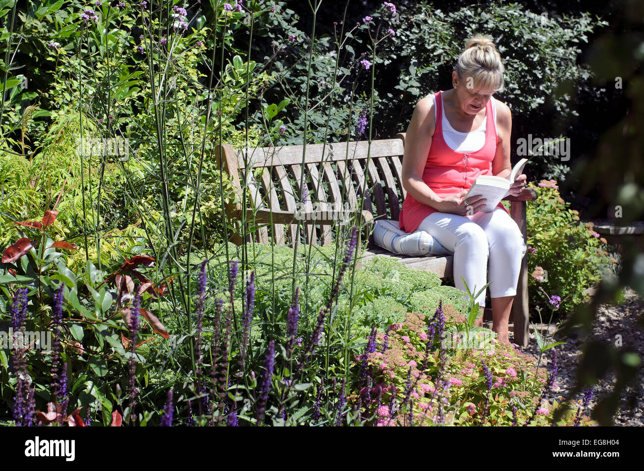 Woman sitting reading in the garden release available for certain uses ...