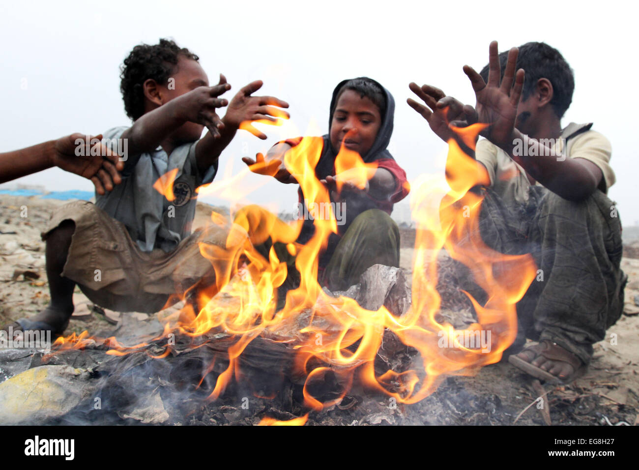 Homeless children create fire by using discarded wood or plastic to ...