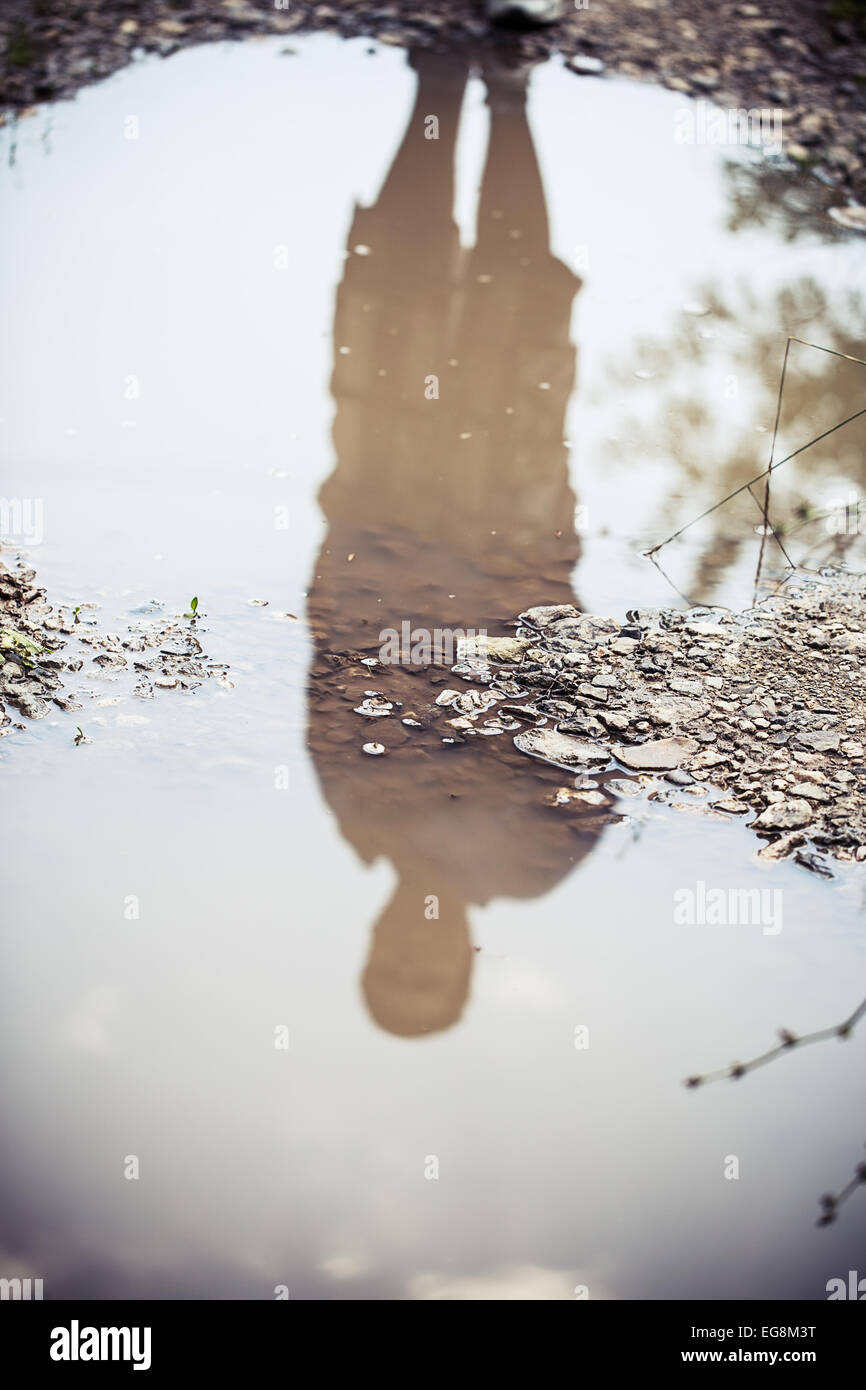 silhouette in a puddle man day the outside Stock Photo - Alamy
