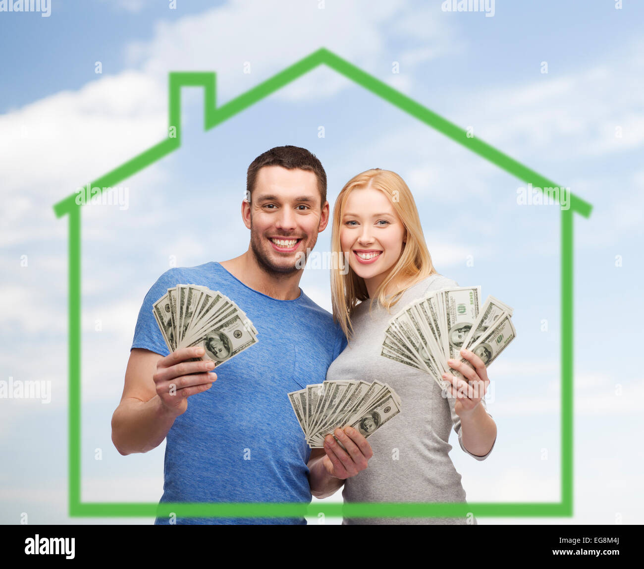 smiling couple holding money over green house Stock Photo - Alamy