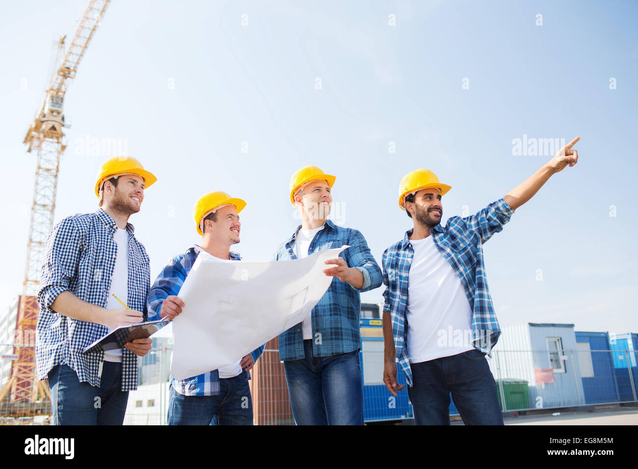 group of builders with tablet pc and blueprint Stock Photo - Alamy