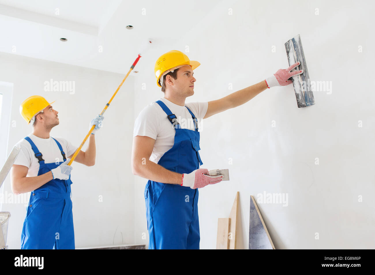 group of builders with tools indoors Stock Photo - Alamy