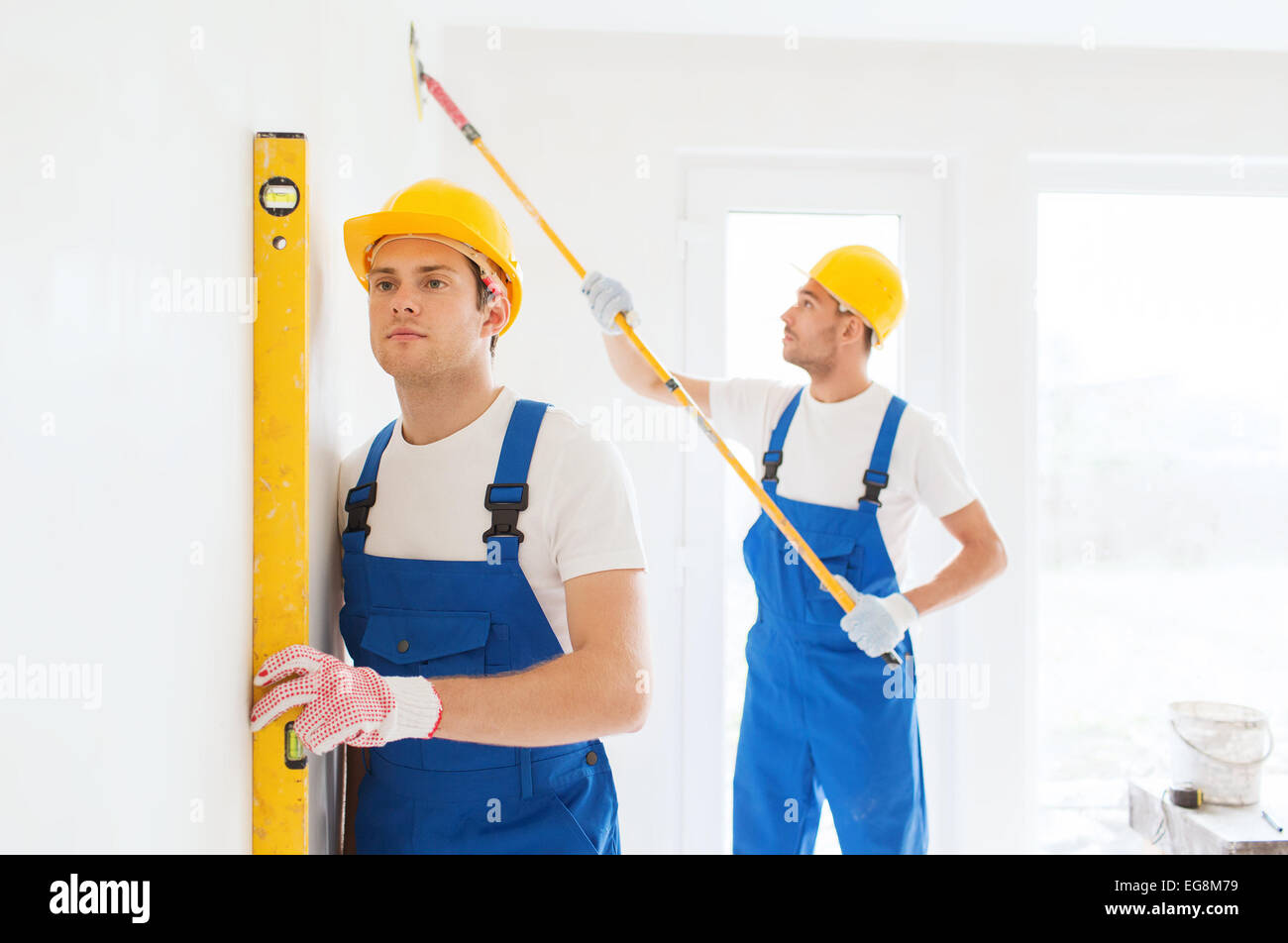group of builders with tools indoors Stock Photo - Alamy