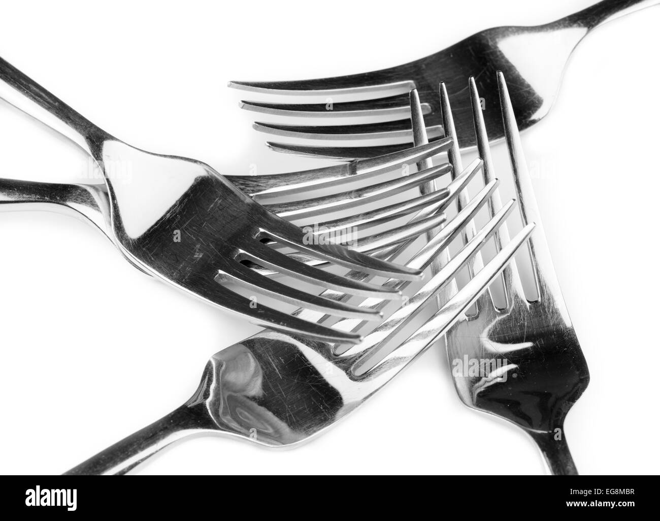 Several stainless steel forks on a white background Stock Photo - Alamy