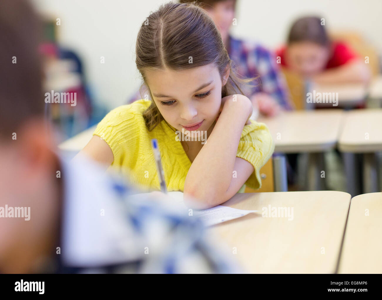 group of school kids writing test in classroom Stock Photo - Alamy