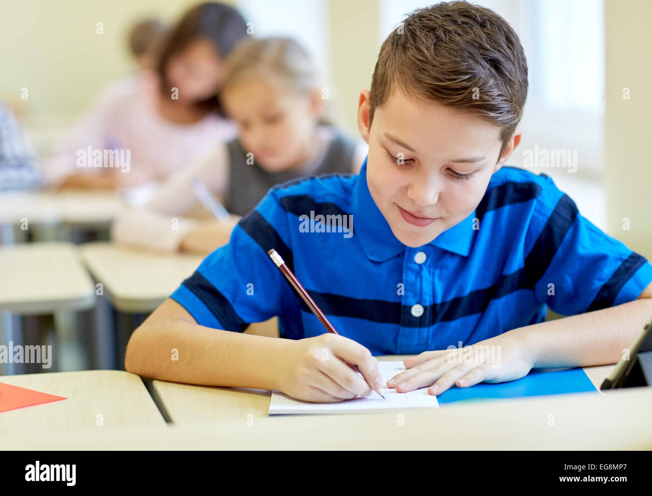 group of school kids writing test in classroom Stock Photo - Alamy