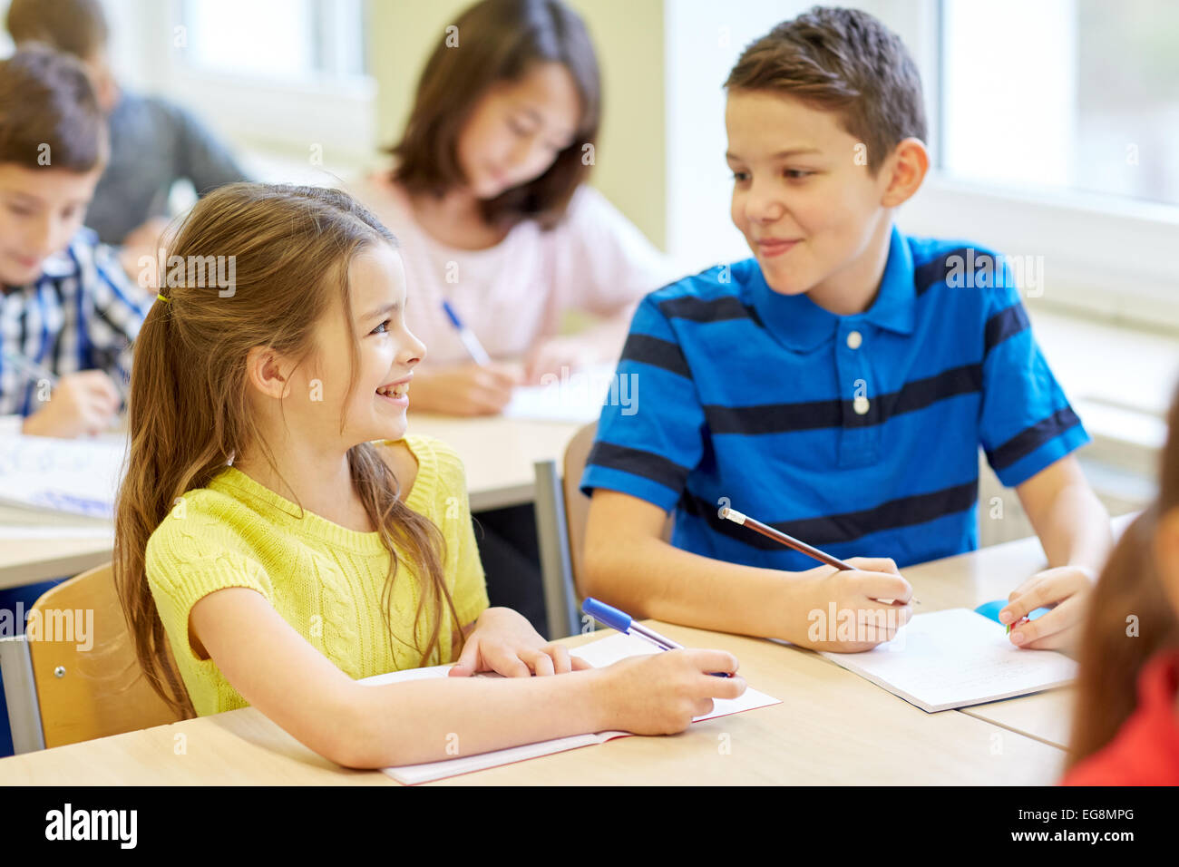 group of school kids writing test in classroom Stock Photo - Alamy
