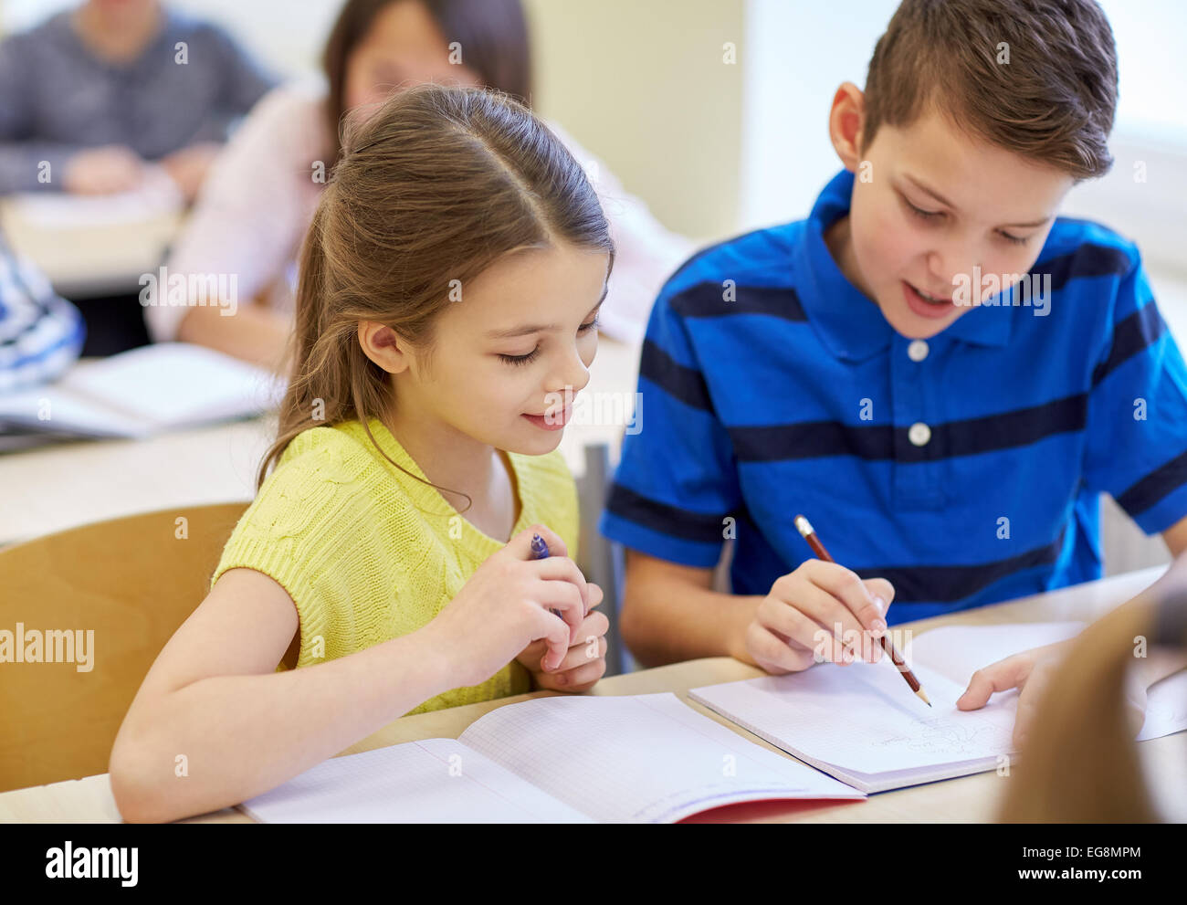 group of school kids writing test in classroom Stock Photo - Alamy