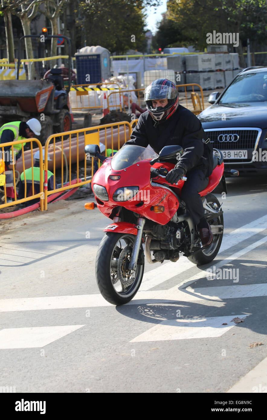 Man riding a motorcycle near construction Stock Photo - Alamy