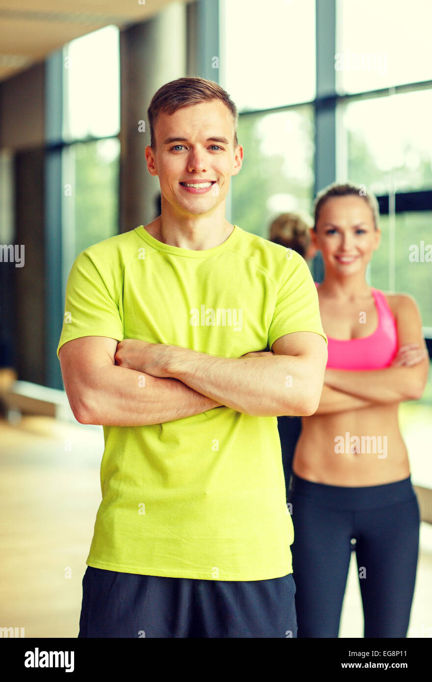 smiling man and woman in gym Stock Photo - Alamy