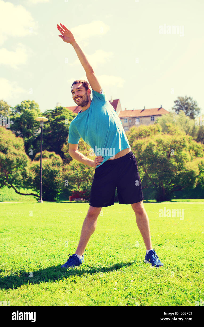 smiling man stretching outdoors Stock Photo - Alamy