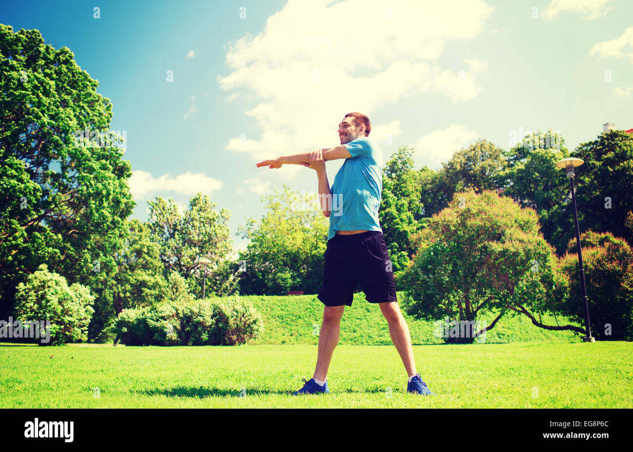 smiling man stretching outdoors Stock Photo - Alamy
