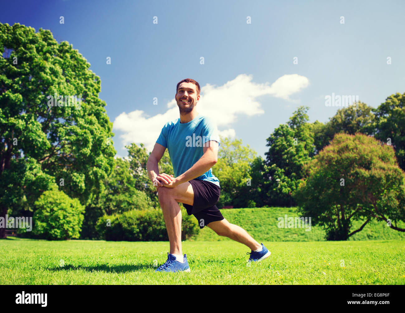 smiling man stretching outdoors Stock Photo - Alamy