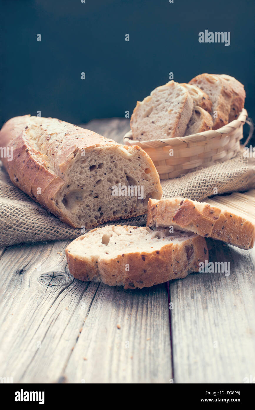 Half bread and slices of it in a basket Stock Photo - Alamy