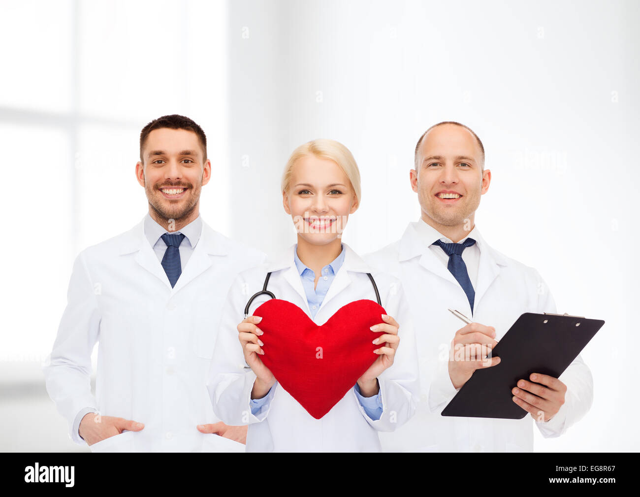 group of smiling doctors with heart and clipboard Stock Photo - Alamy