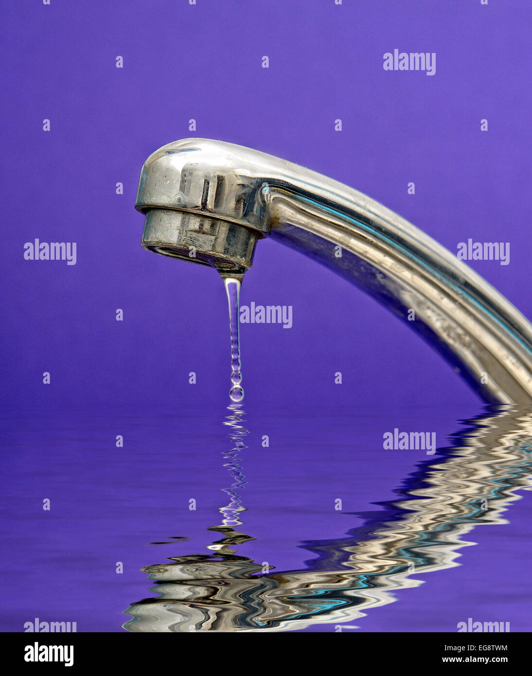 Water droplets falling from a kitchen tap into a digitally created pool ...