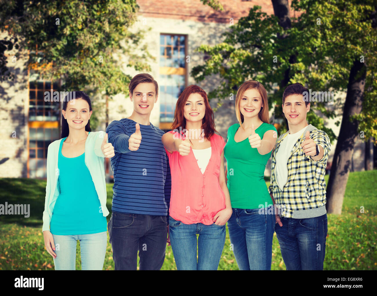 group of smiling students showing thumbs up Stock Photo - Alamy
