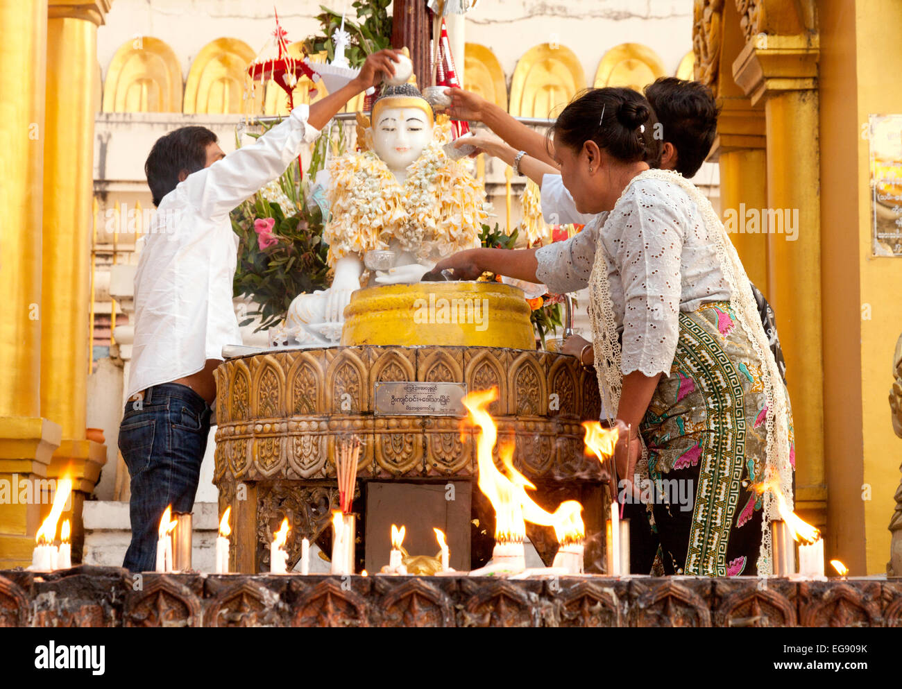 Burmese people making an offering at a buddhist shrine, Shwedagon ...