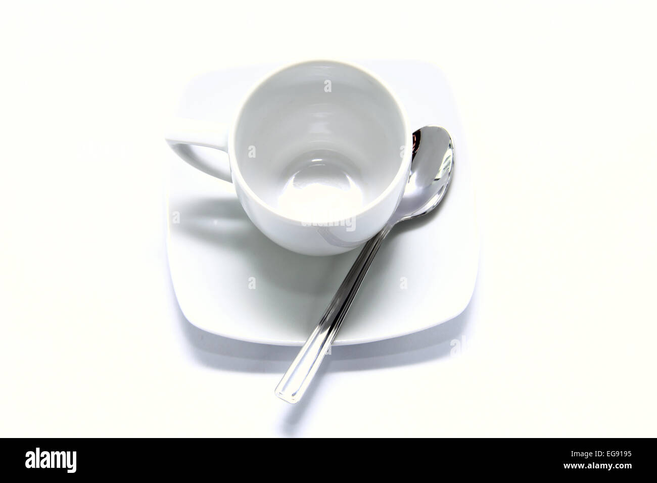 white cup with tea spoon isolated on white background Stock Photo - Alamy