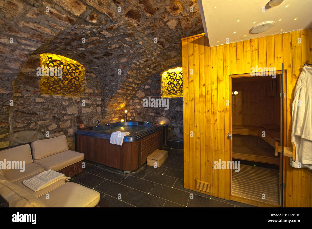 Luxurious jacuzzi and sauna with stone wall Stock Photo - Alamy
