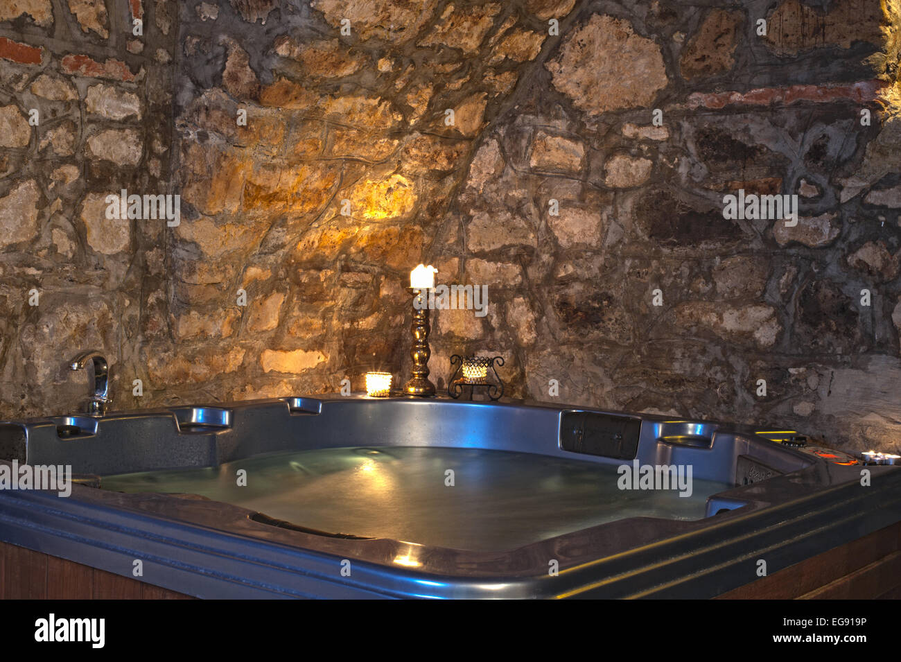 Luxurious jacuzzi with stone wall Stock Photo - Alamy