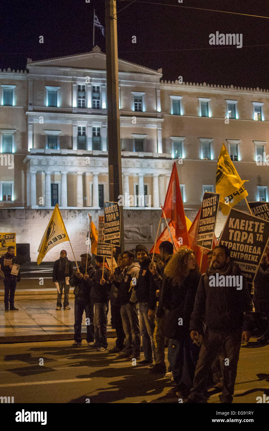 Demonstrators stand in front of the Greek parliament shouting slogans ...