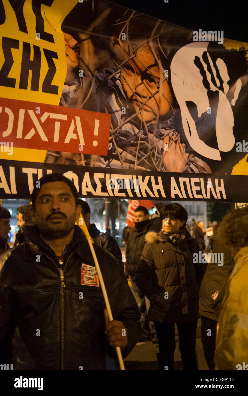 Demonstrator stands in front of a banner carrying an image of a child ...