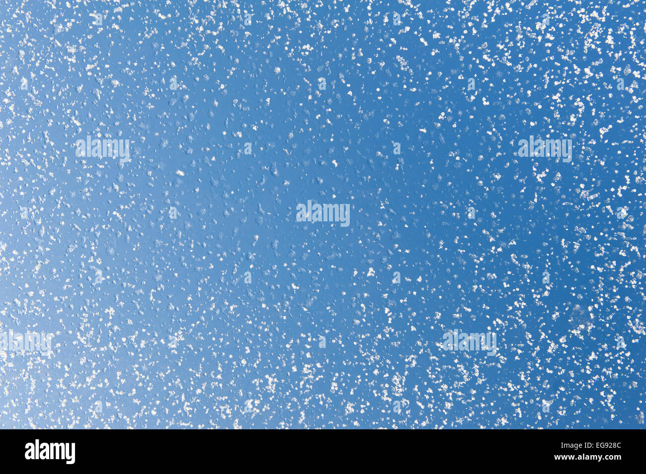 Melting snow spots blue sky background Stock Photo - Alamy