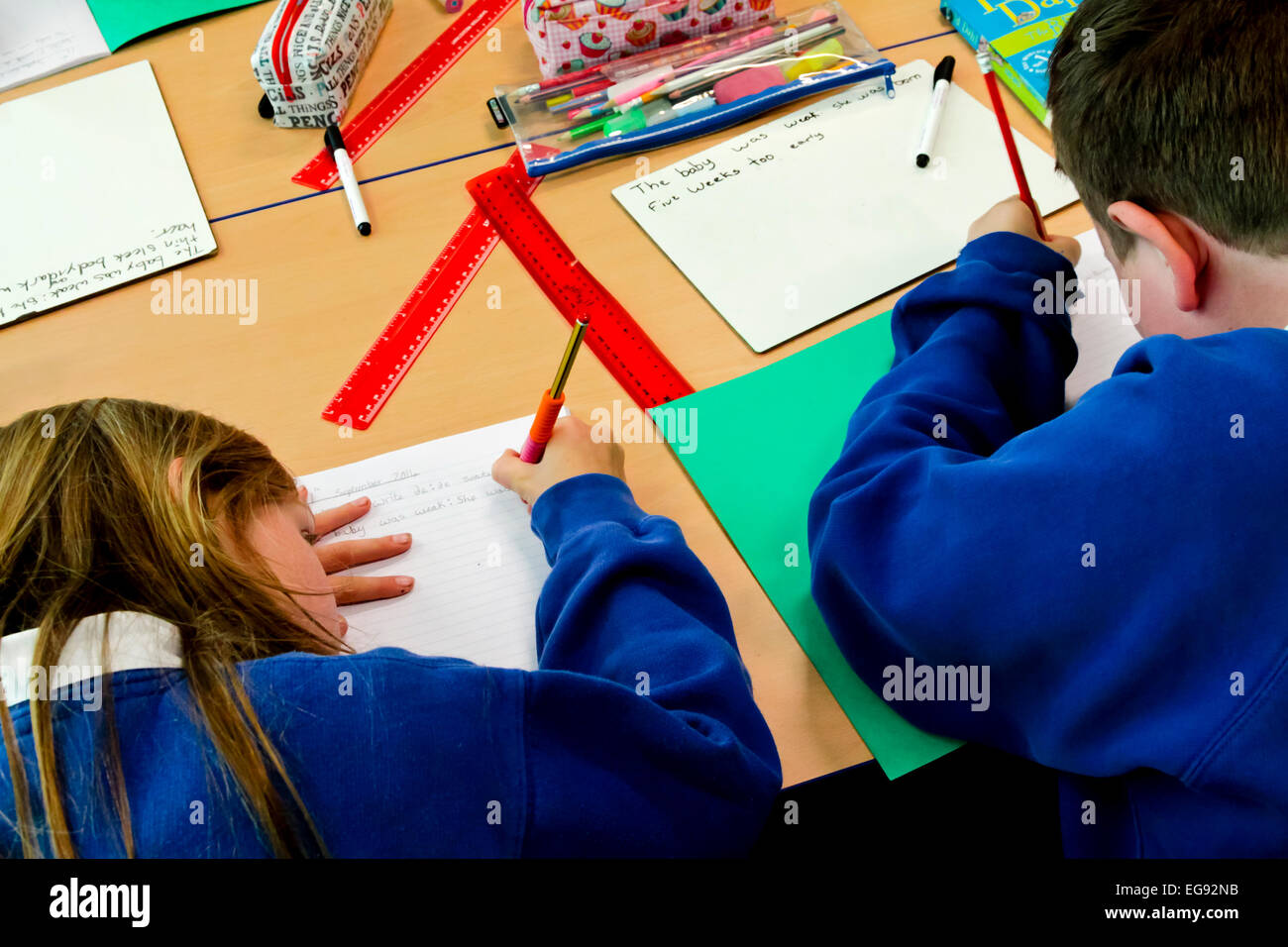 Primary school children writing with a pencil during a lesson Stock ...