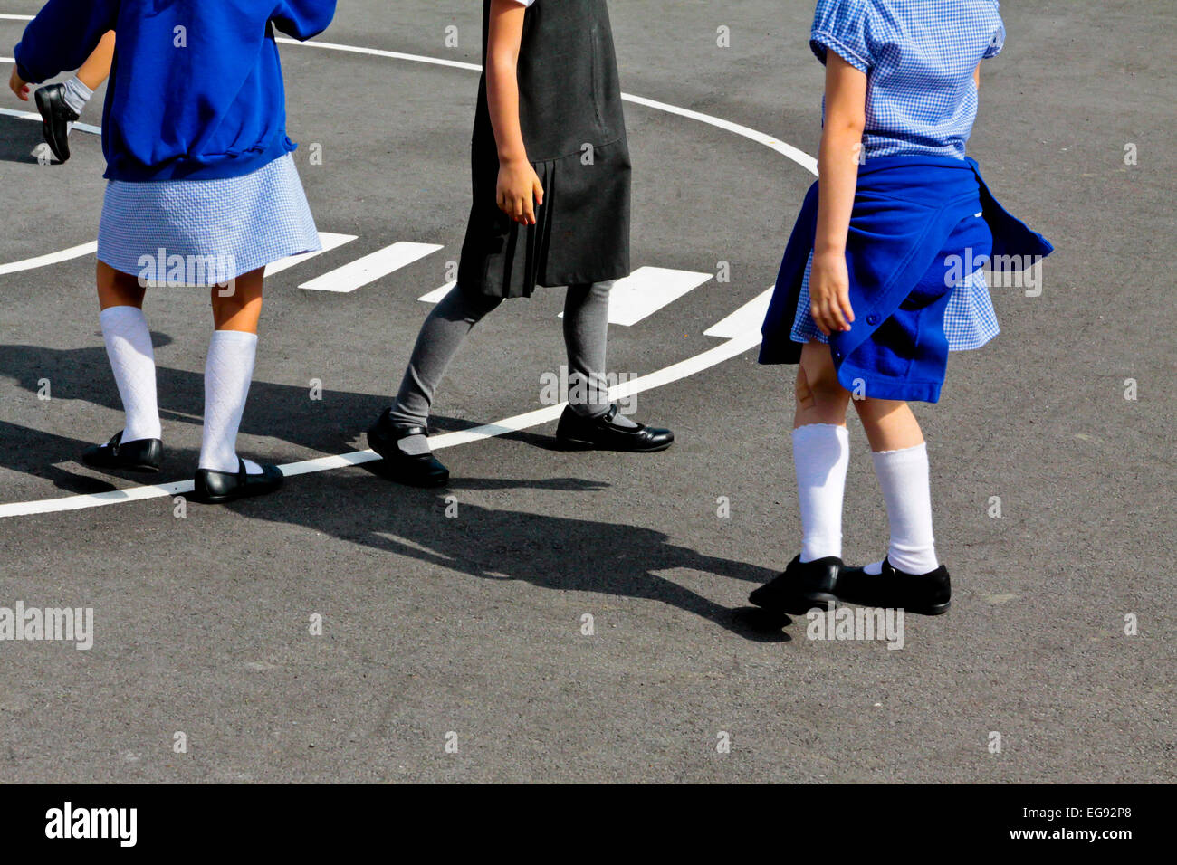 Primary schoolchildren playing in a school playground at break time ...